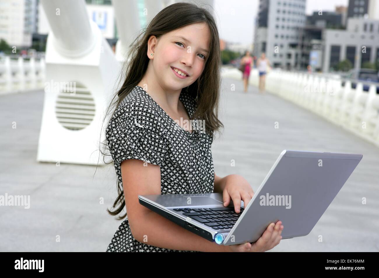 Beautiful little girl with laptop computer Stock Photo - Alamy