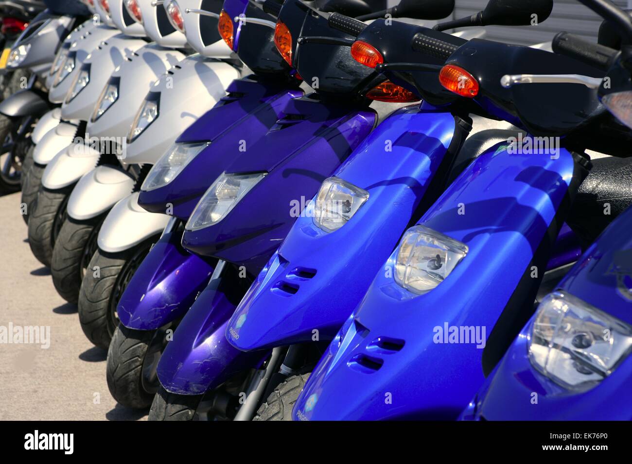 Scooter motorbikes in a row with perspective Stock Photo - Alamy