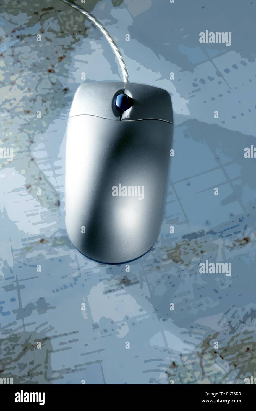Computer silver wired mouse over blue map Stock Photo - Alamy