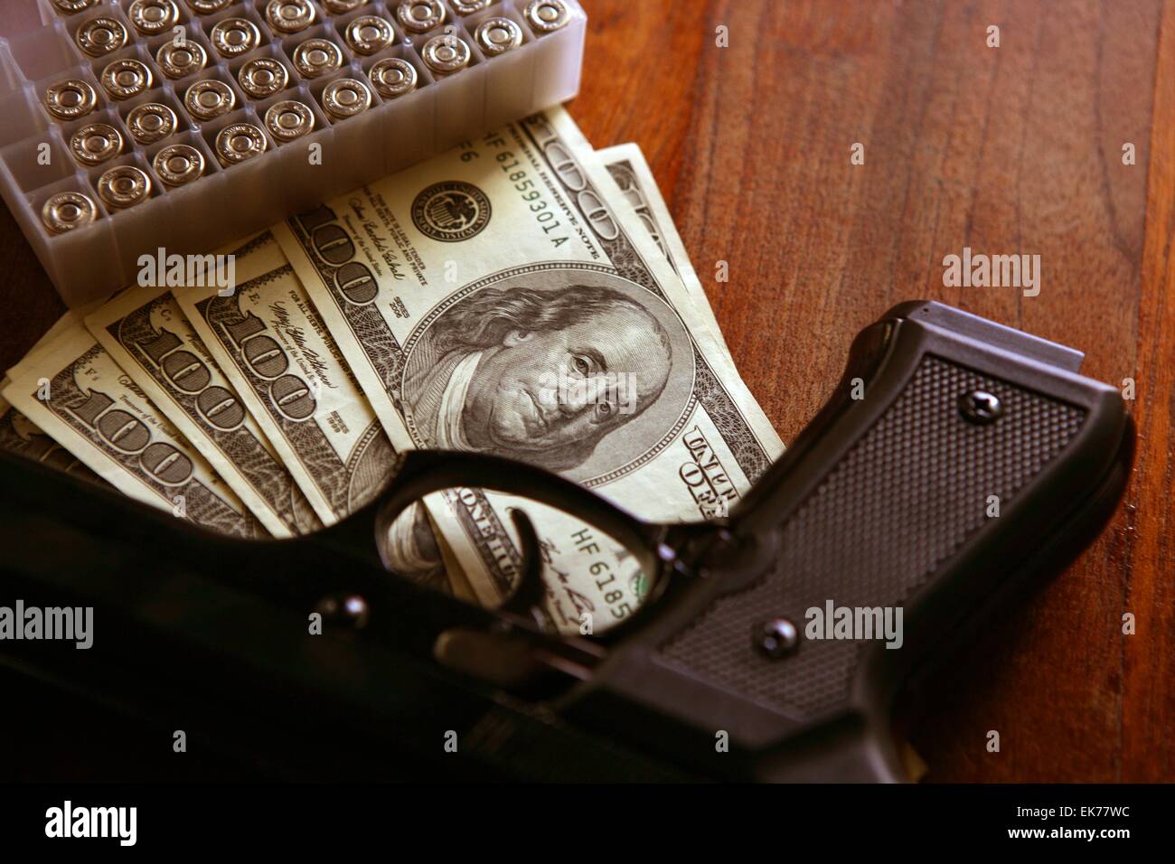 Dollar notes and gun, black pistol Stock Photo - Alamy