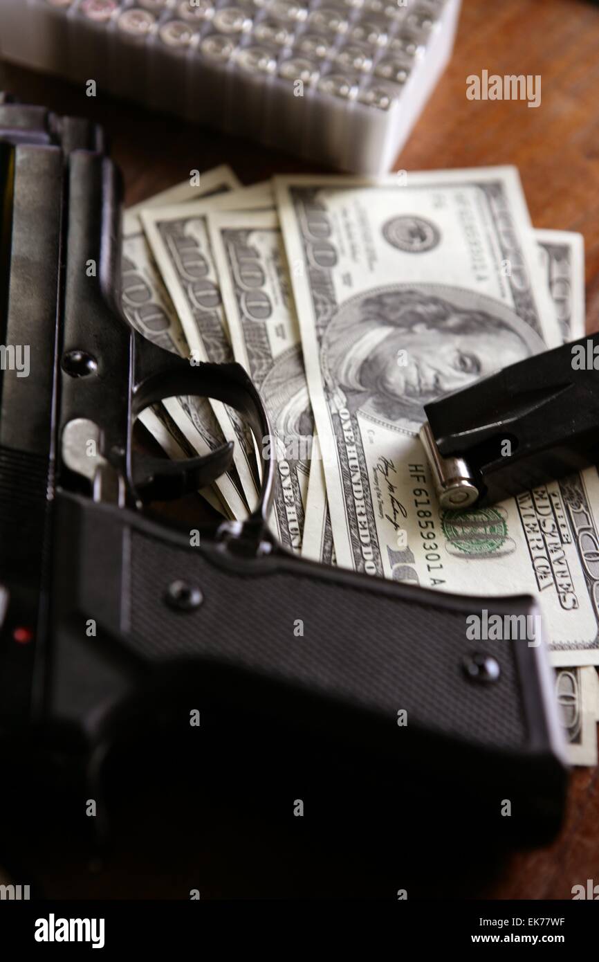 Dollar notes and gun, black pistol Stock Photo - Alamy