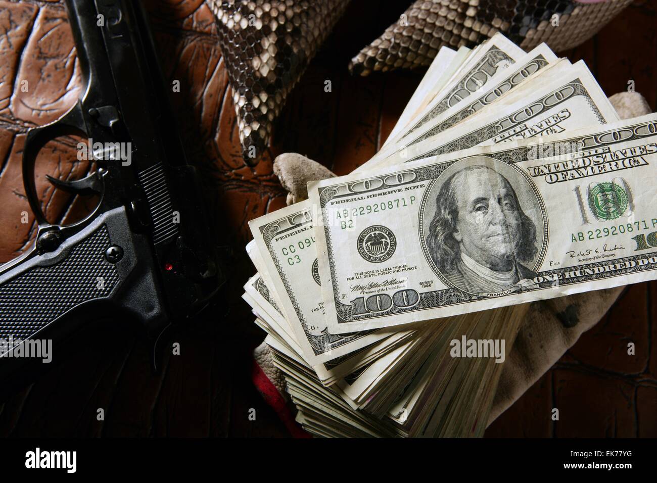 Dollar notes and gun, black pistol Stock Photo - Alamy
