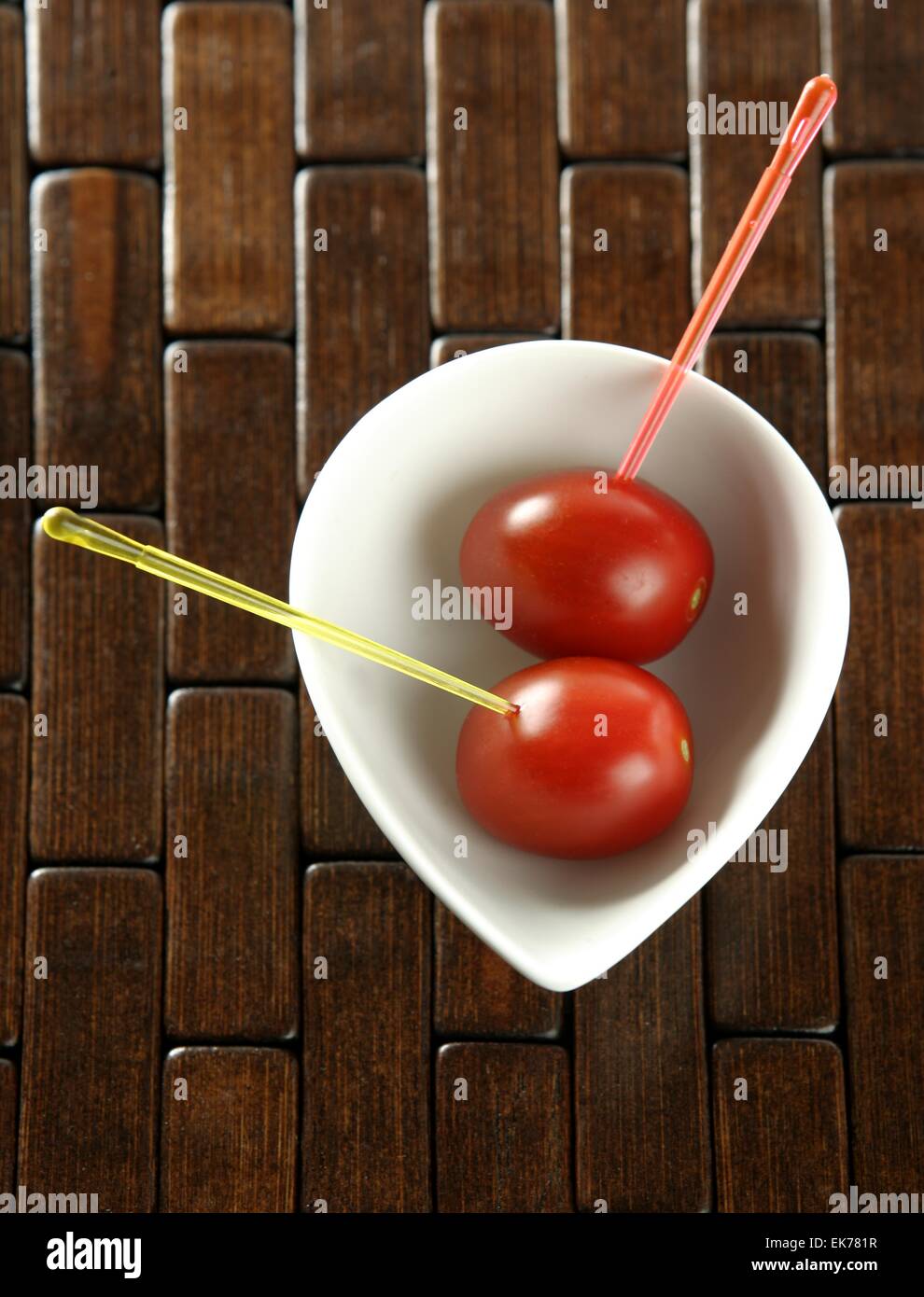 Tomatoes snack and colored sticks Stock Photo - Alamy