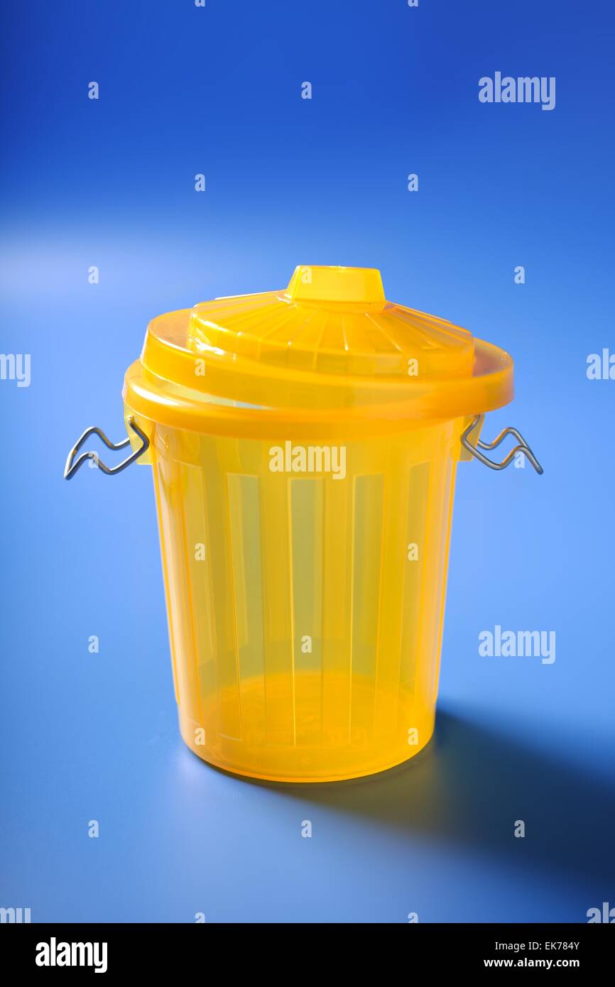 Yellow trash dustbin Stock Photo - Alamy