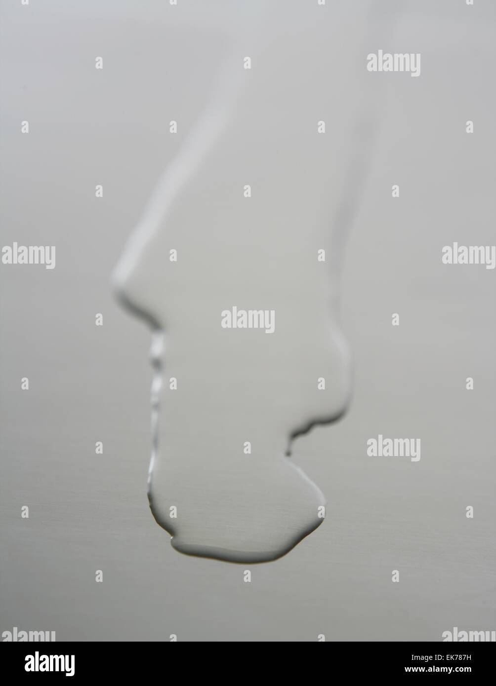 Liquid, oil shape on a metal surface Stock Photo - Alamy