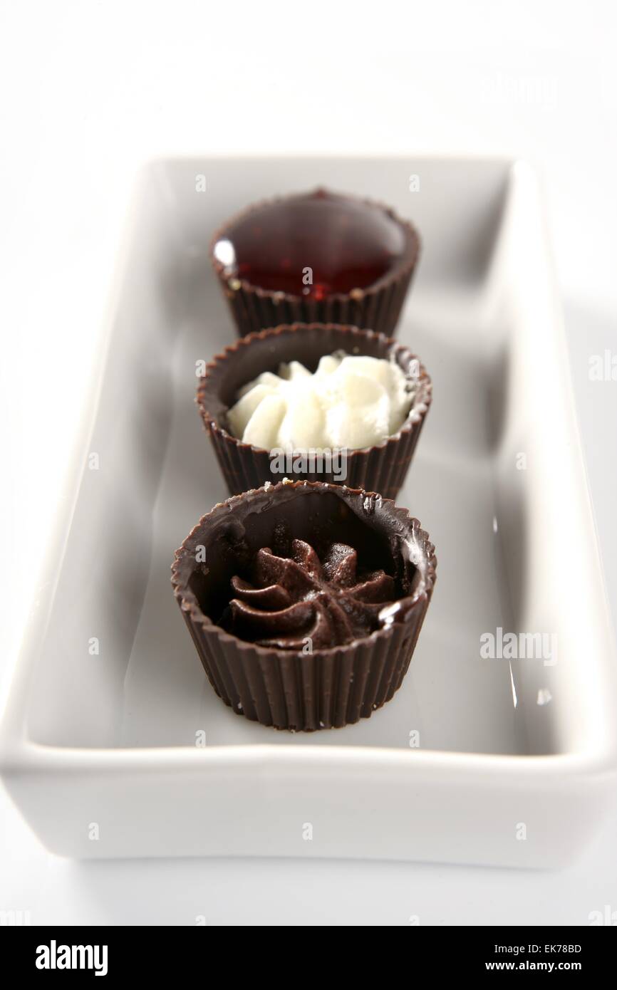 Three little chocolate cakes in a line Stock Photo - Alamy