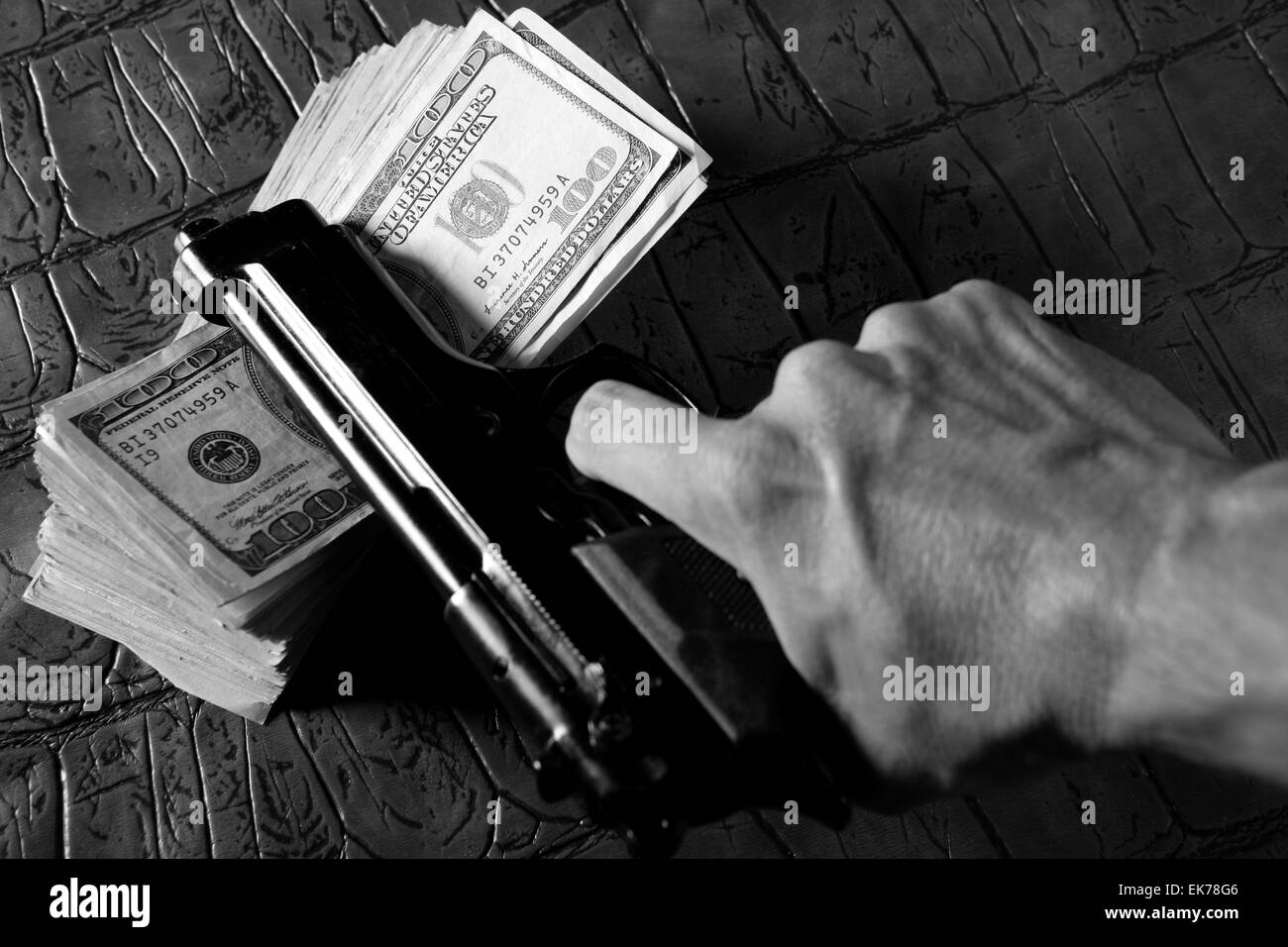 Dollar notes and gun, black pistol Stock Photo - Alamy