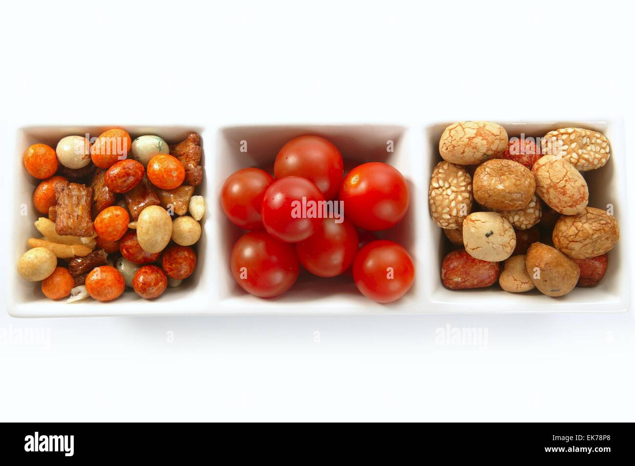 Triple bowl with varied japanese snacks and tomatoes Stock Photo - Alamy