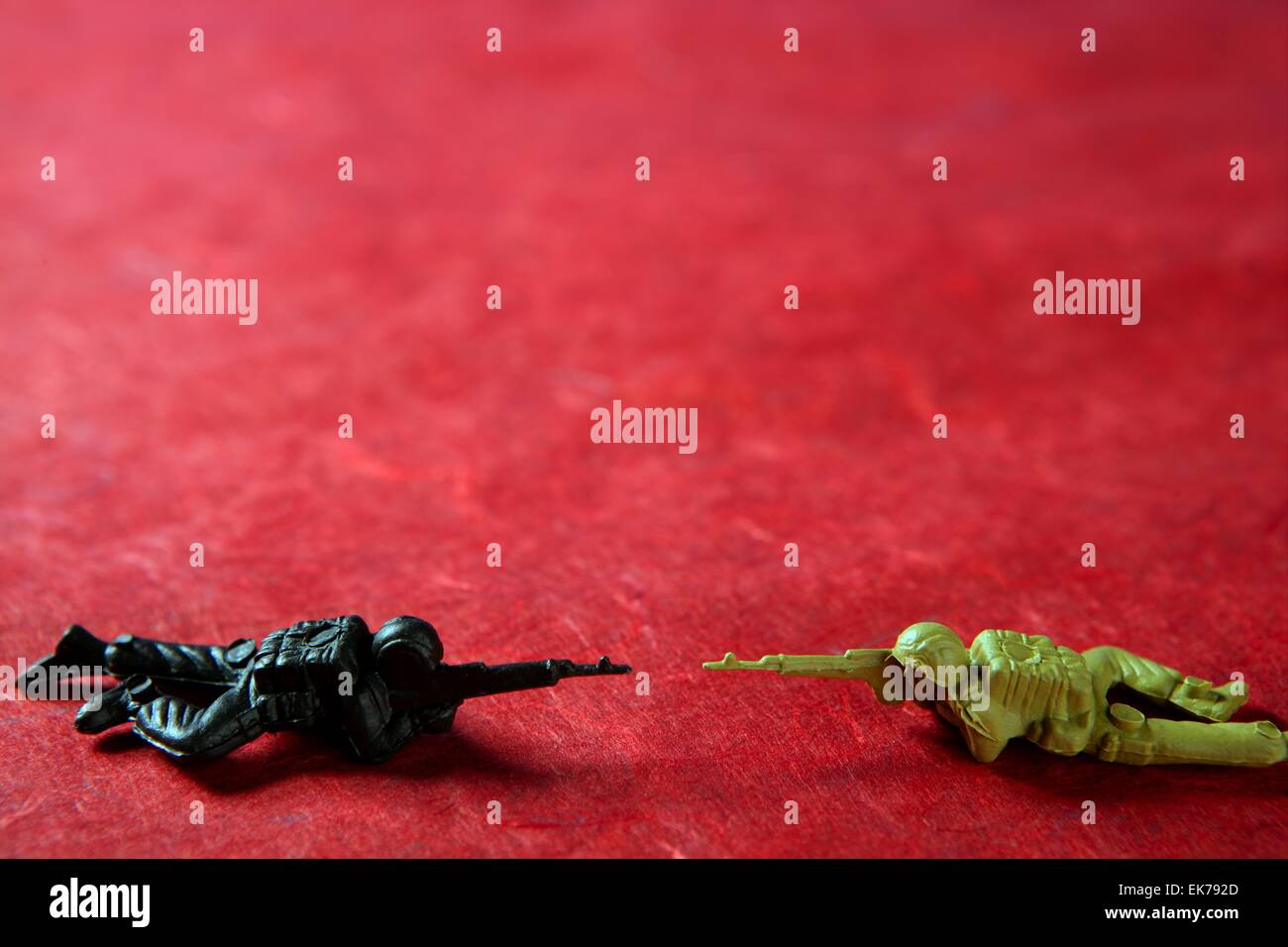 Two plastic toy soldier over red Stock Photo - Alamy
