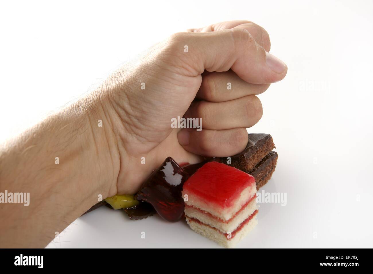hand hits little cakes with closed fist Stock Photo - Alamy