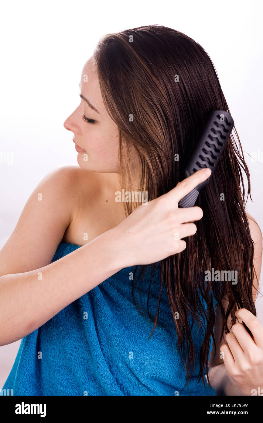 Woman is grooming her hair Stock Photo - Alamy