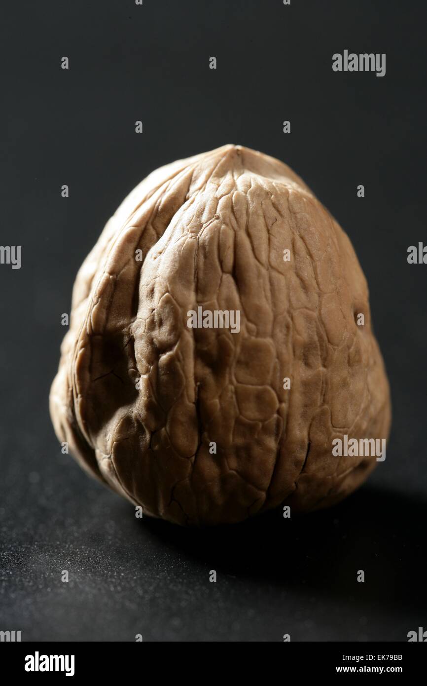 One walnut with shells over black background Stock Photo - Alamy