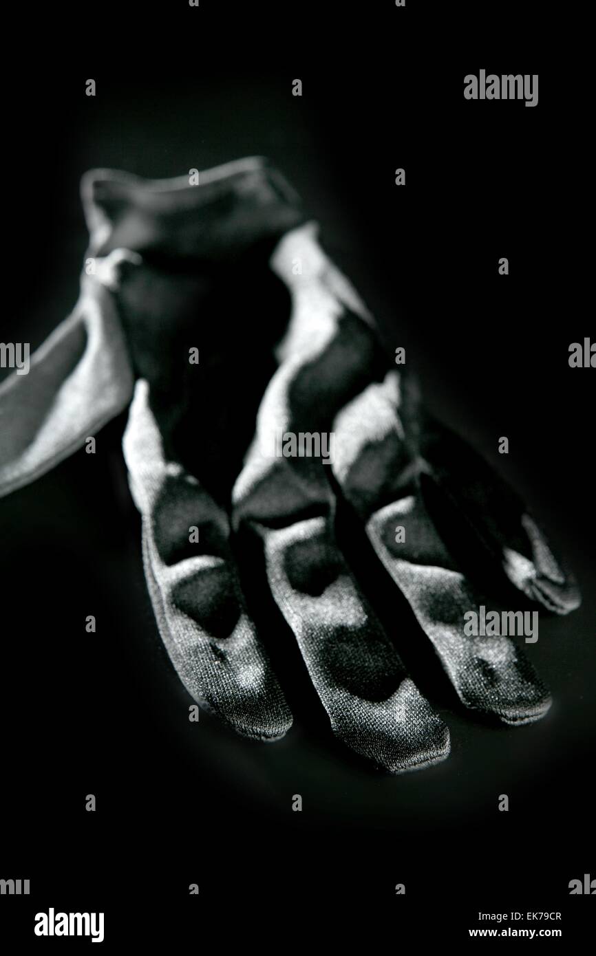 Dirty job with black gloves metaphor Stock Photo - Alamy