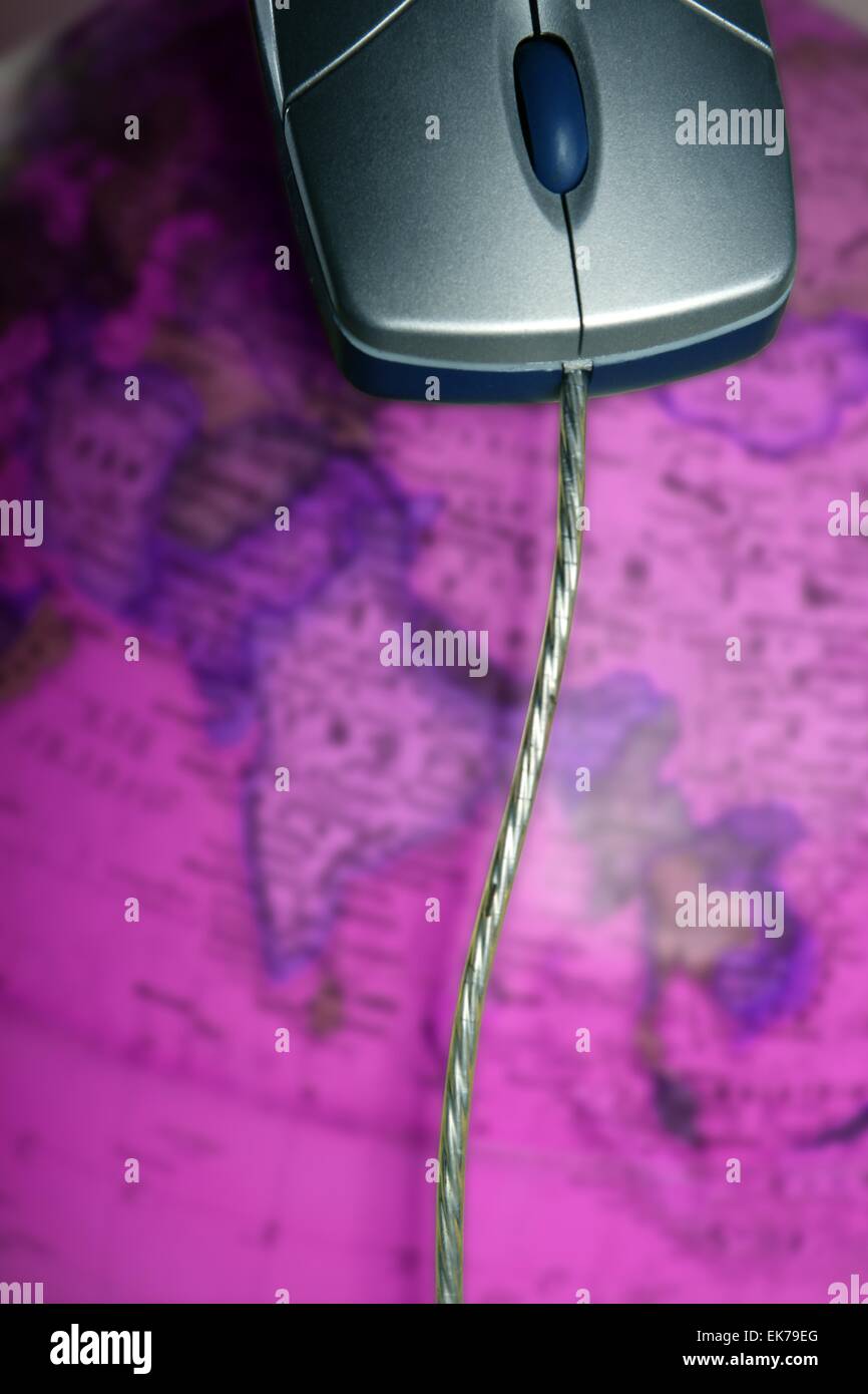 Computer wired mouse over the world global earth map Stock Photo - Alamy