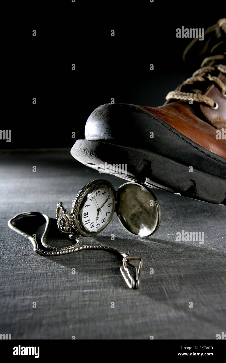 Boot treading an old pocket silver watch Stock Photo - Alamy