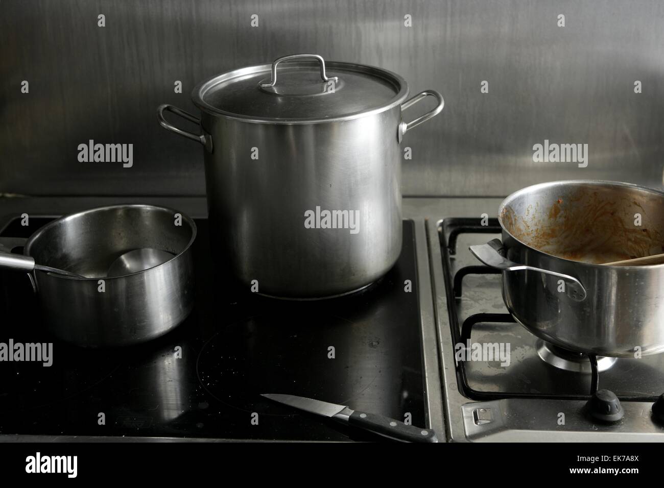Dirty used stainless steel kitchen cooking stuff Stock Photo - Alamy