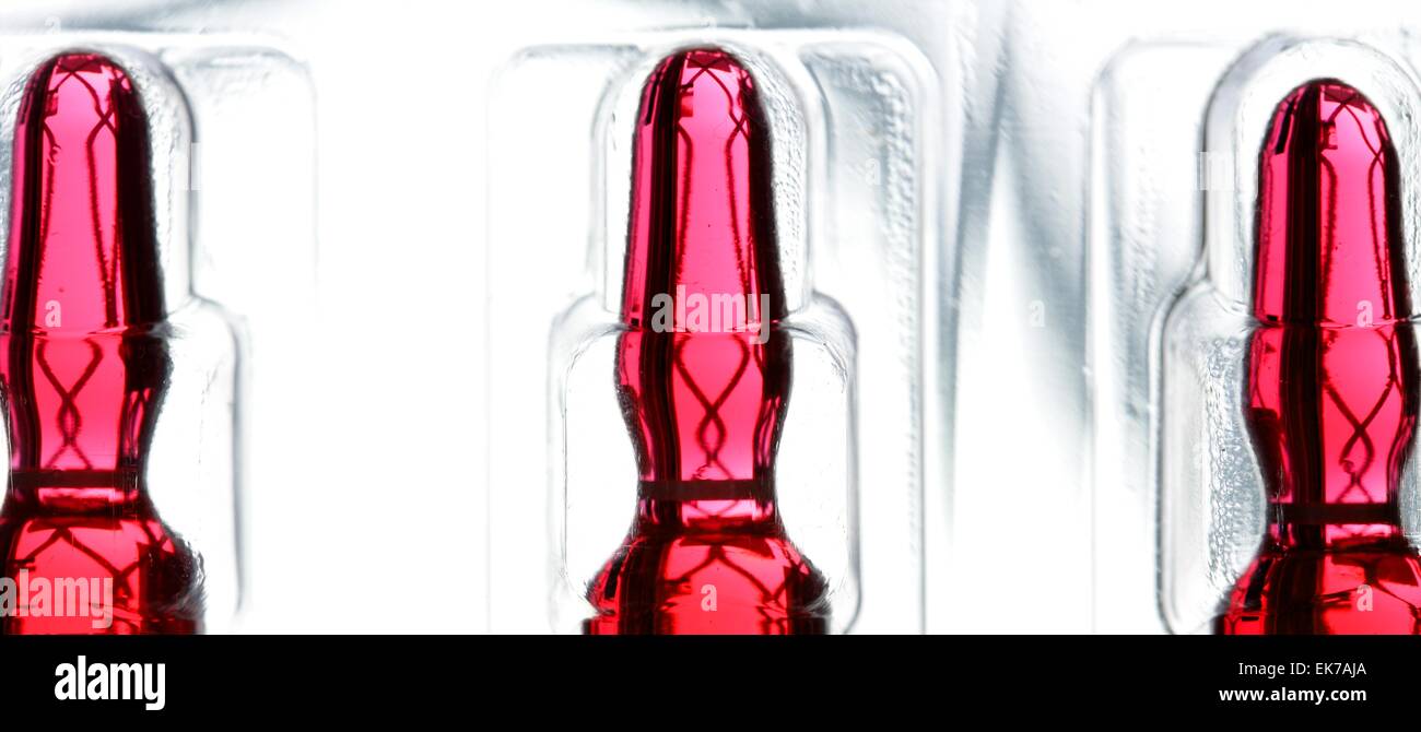 Glass ampoule with red liquid medicine Stock Photo - Alamy