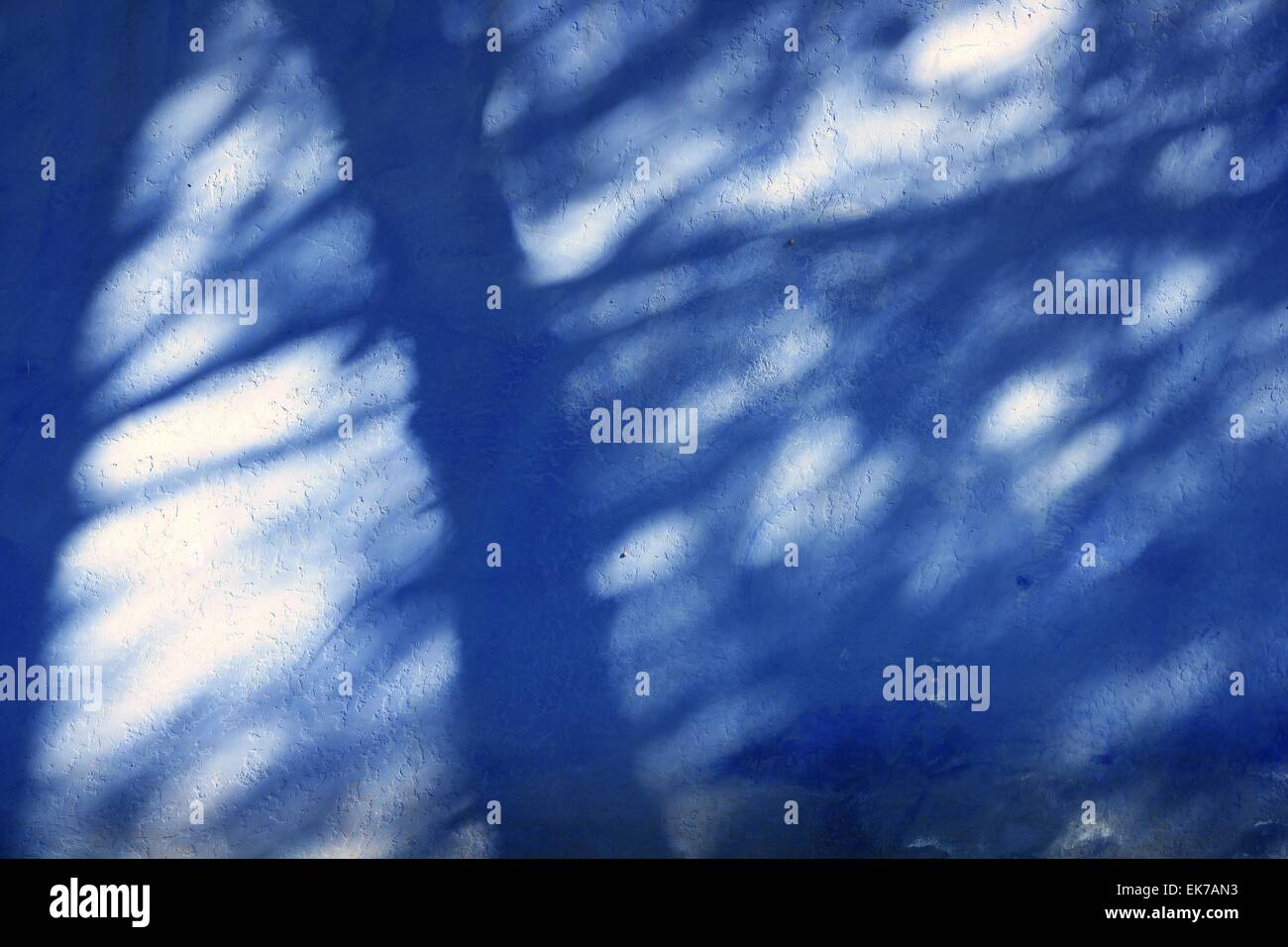 Grunge blue mediterranean garden wall shadows Stock Photo - Alamy