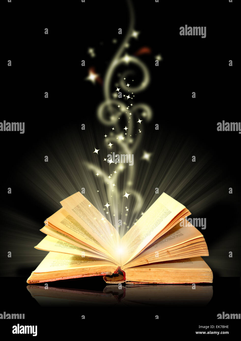 Open book magic on black Stock Photo - Alamy