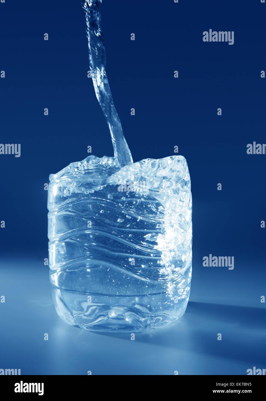 Natural mineral blue water falling down Stock Photo - Alamy