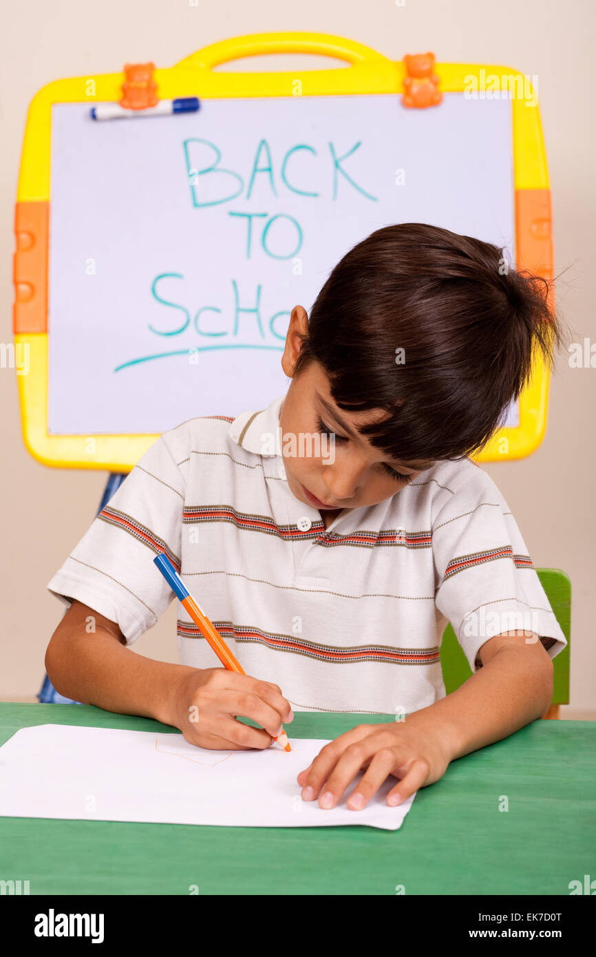 Portrait of a young boy writing notes Stock Photo - Alamy