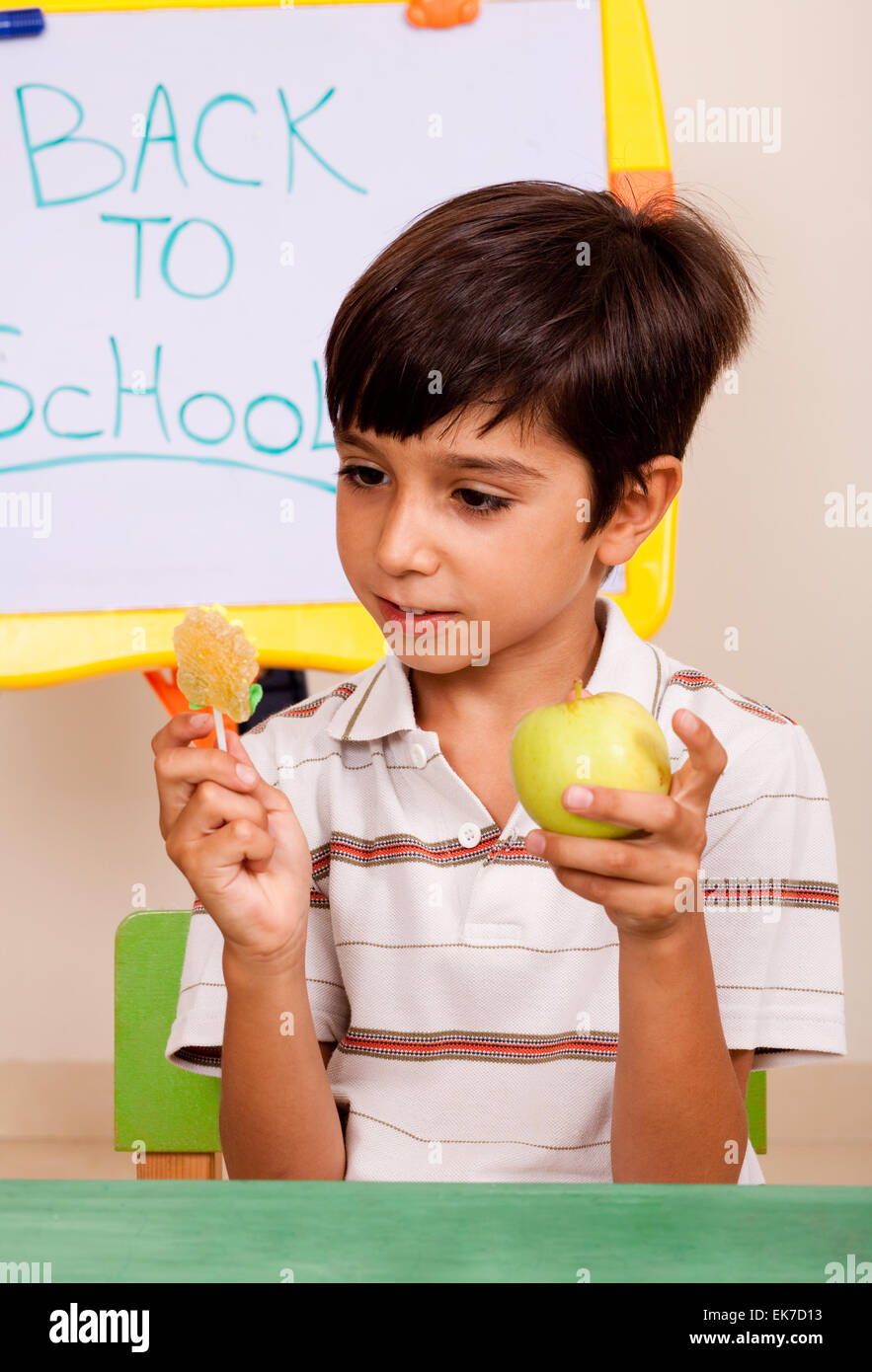 Young kid holding an apple Stock Photo - Alamy