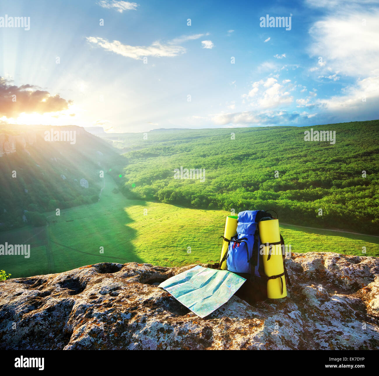 Backpack and map in mountain Stock Photo - Alamy