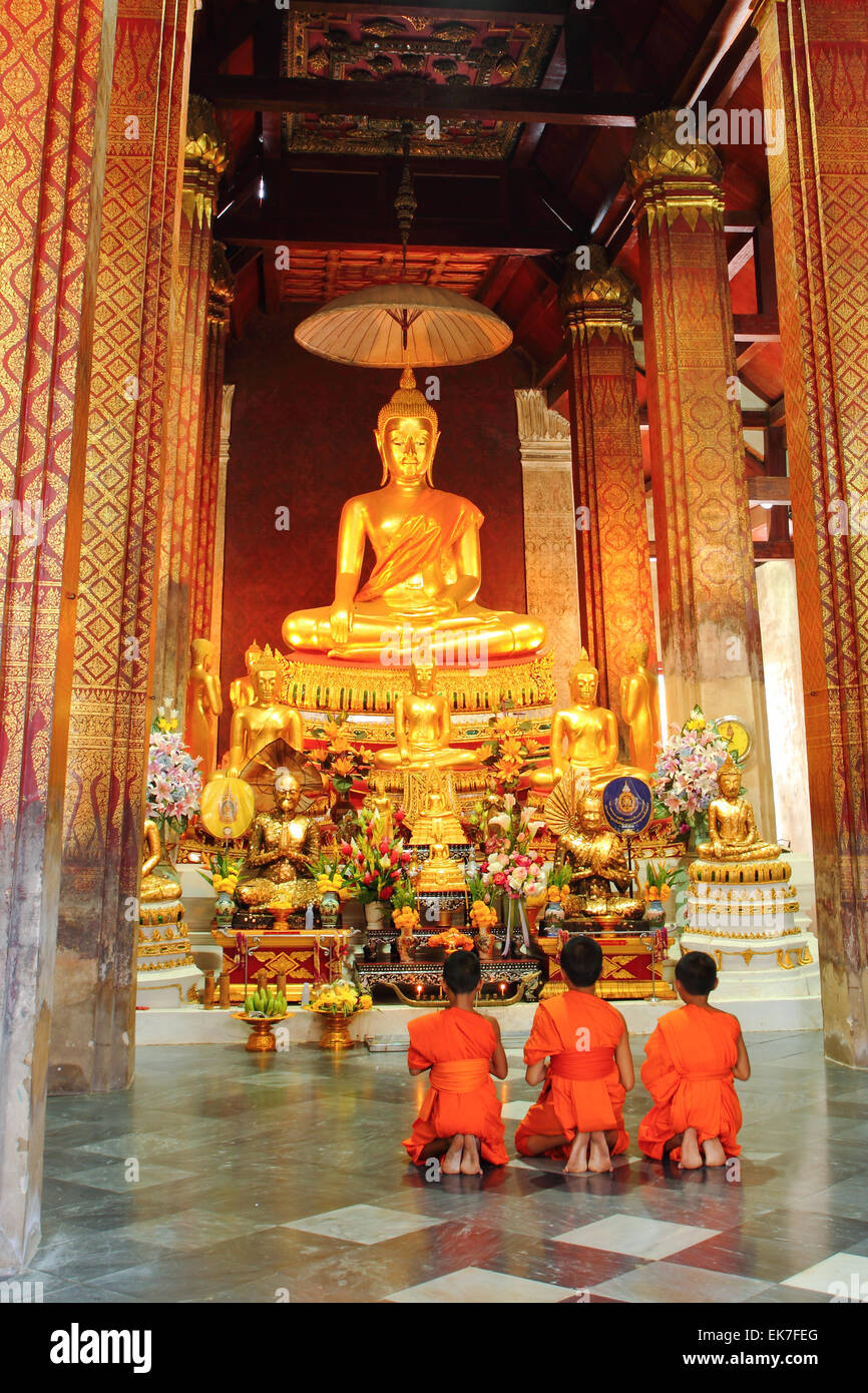 Young monks praying at church Stock Photo - Alamy