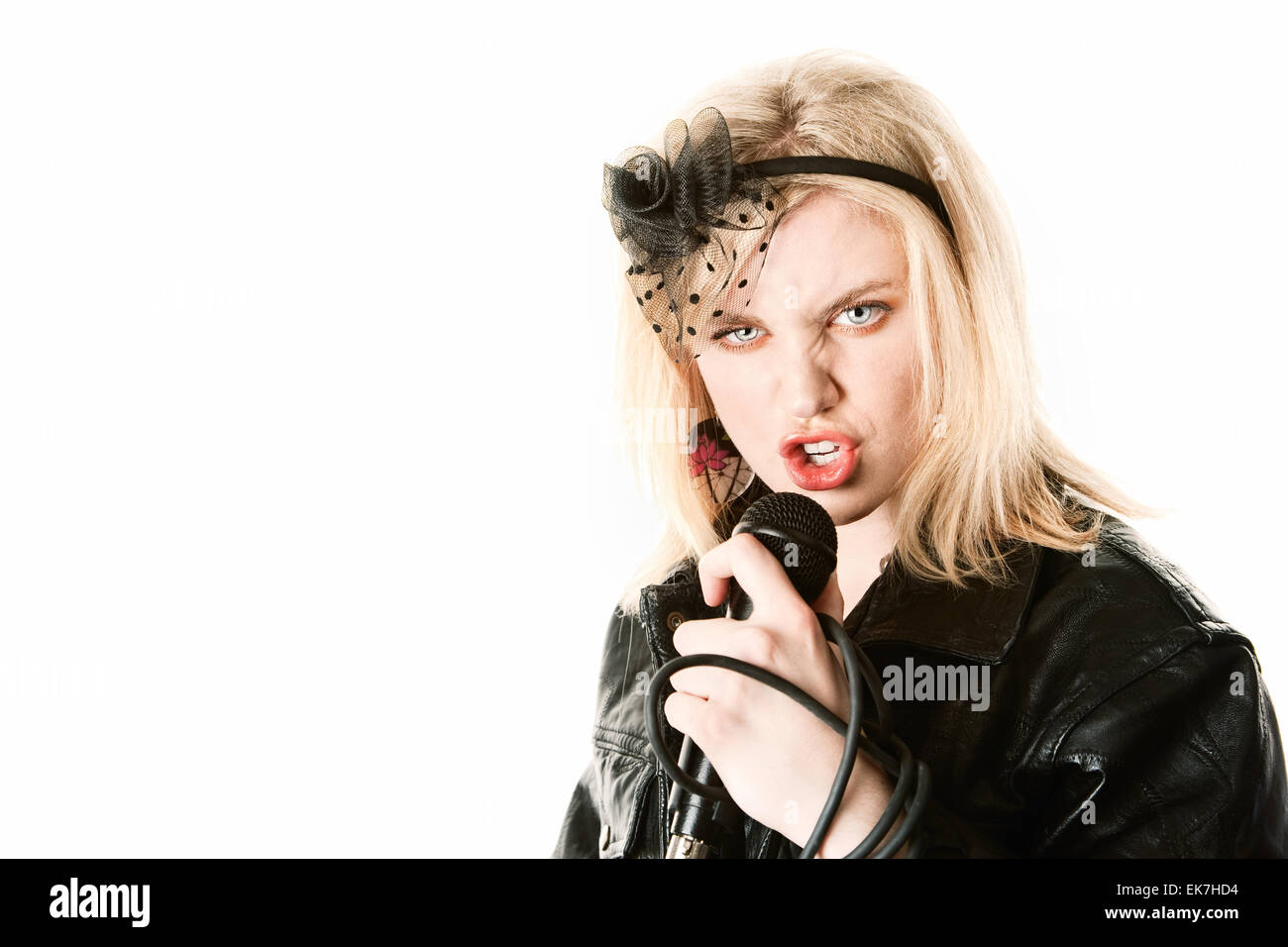 Pretty young singer or comedian with microphone Stock Photo - Alamy