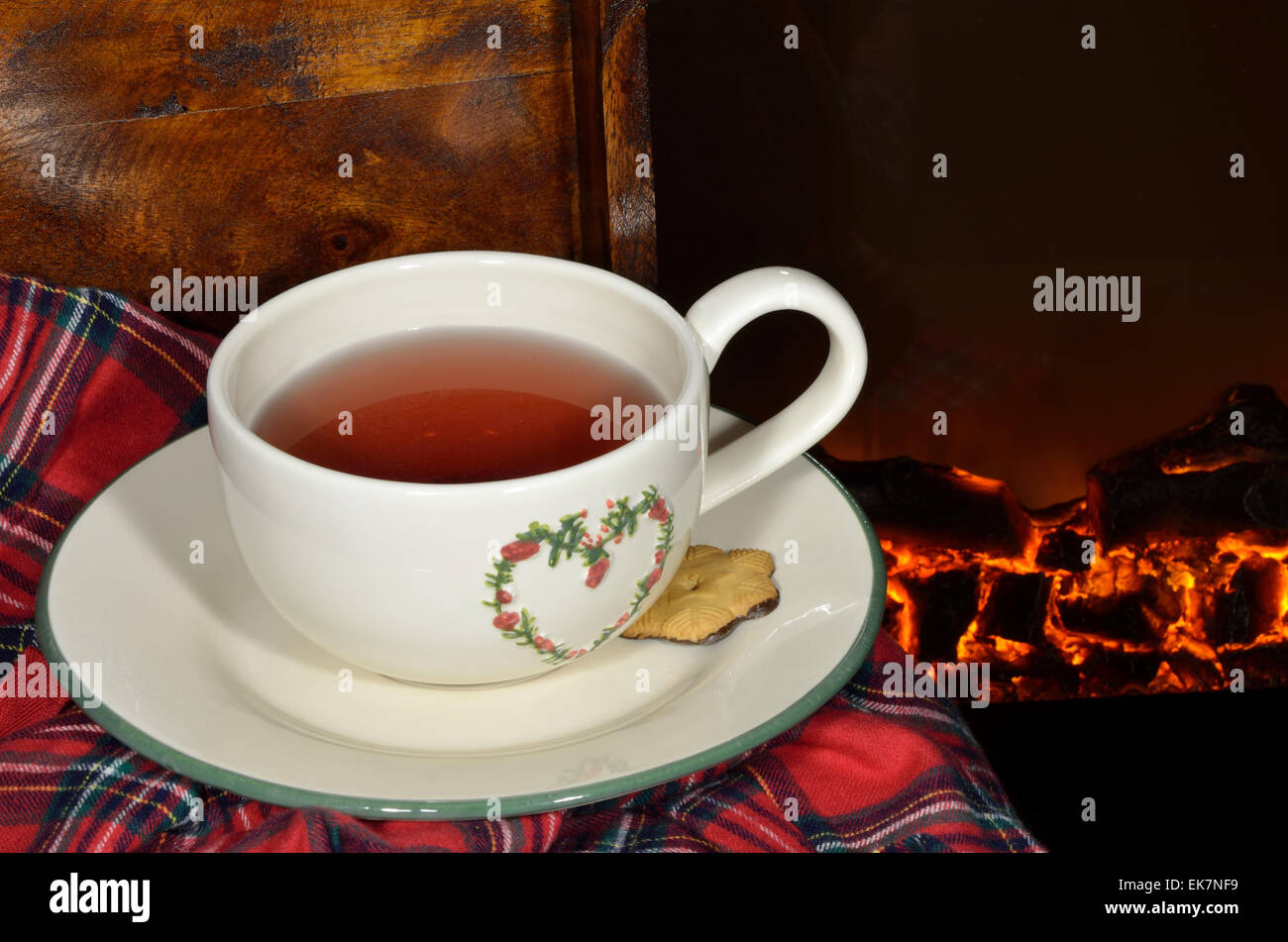 A cup of tea by the fireplace, in a cold winter night Stock Photo - Alamy