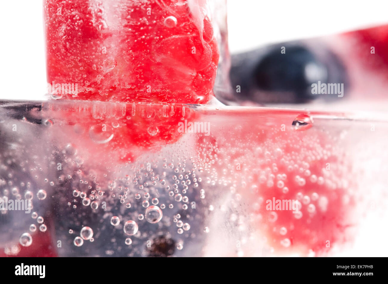 Raspberry and blackberry frozen in ice sticks Stock Photo - Alamy