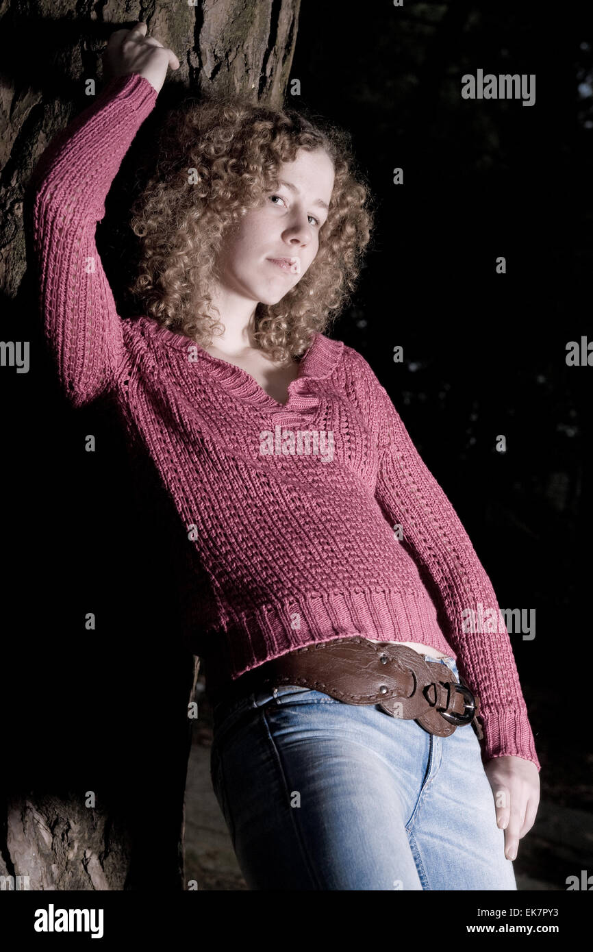 Leaning against a tree Stock Photo - Alamy