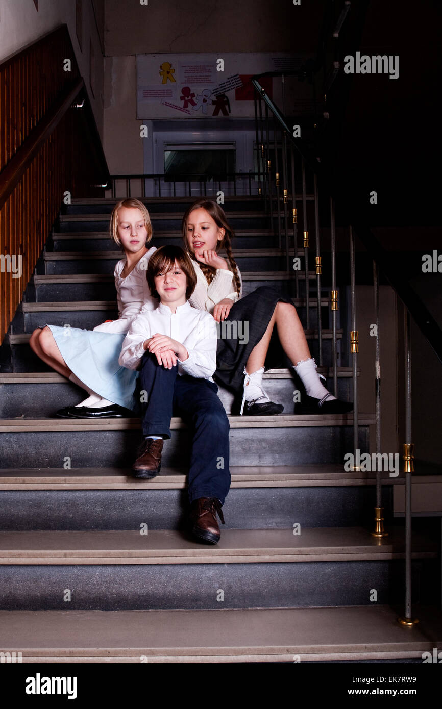 Kids sitting on the stairs Stock Photo - Alamy
