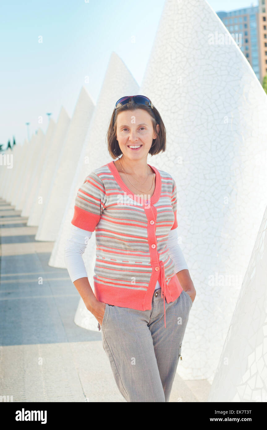 A young woman walking of modern building Stock Photo - Alamy