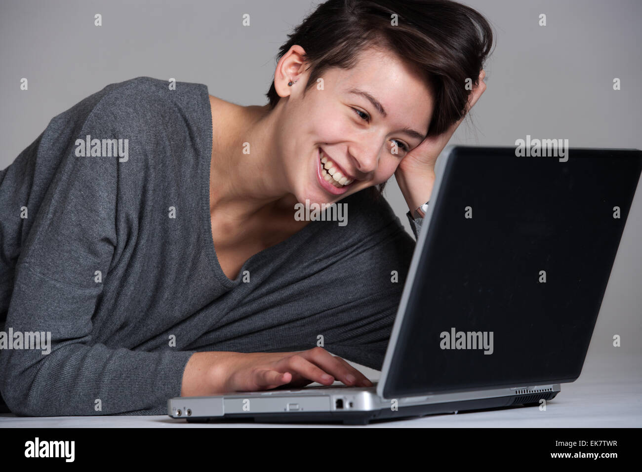 Young woman on floor with notebook Stock Photo - Alamy