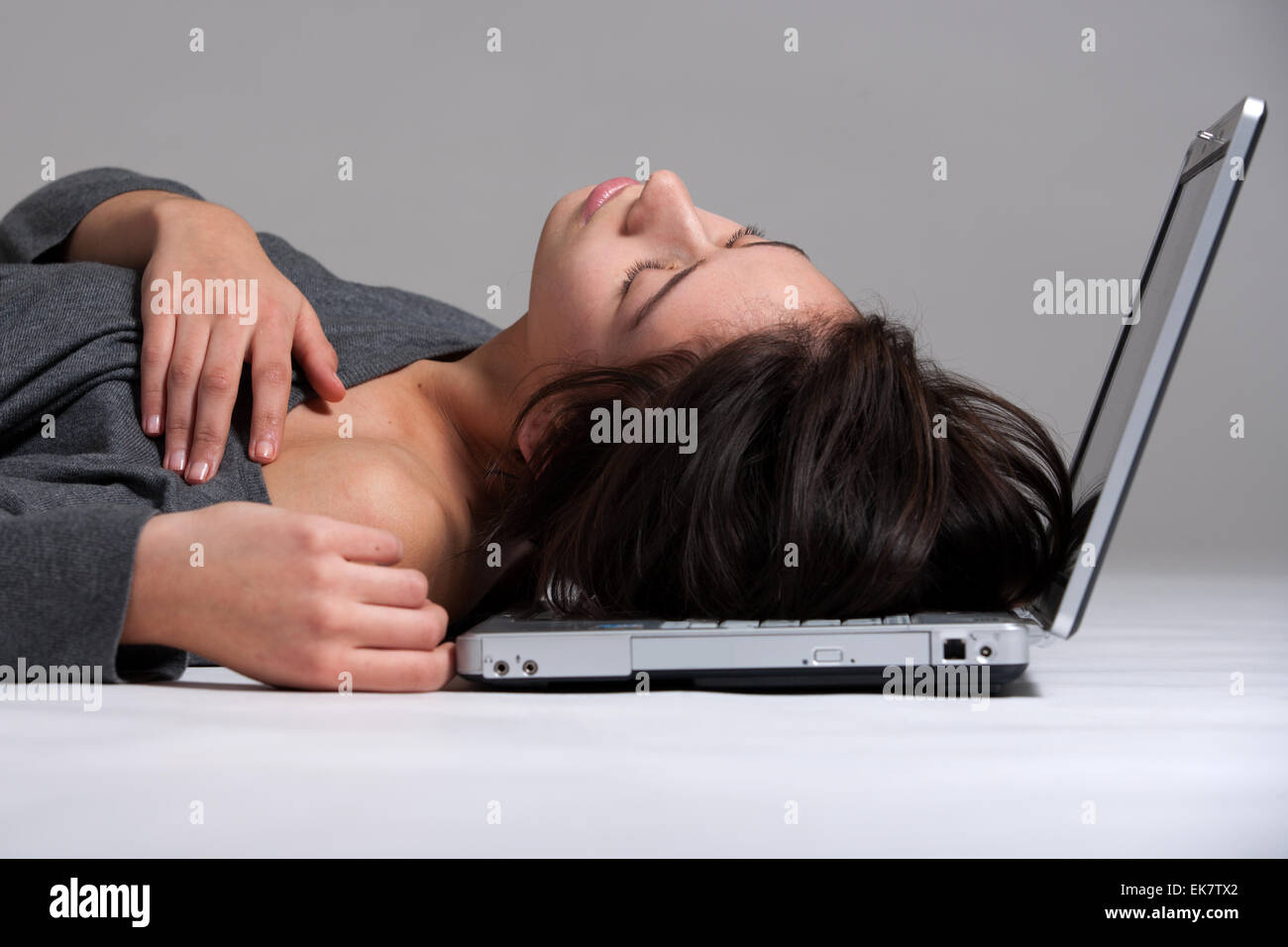 Young woman on floor with notebook Stock Photo - Alamy