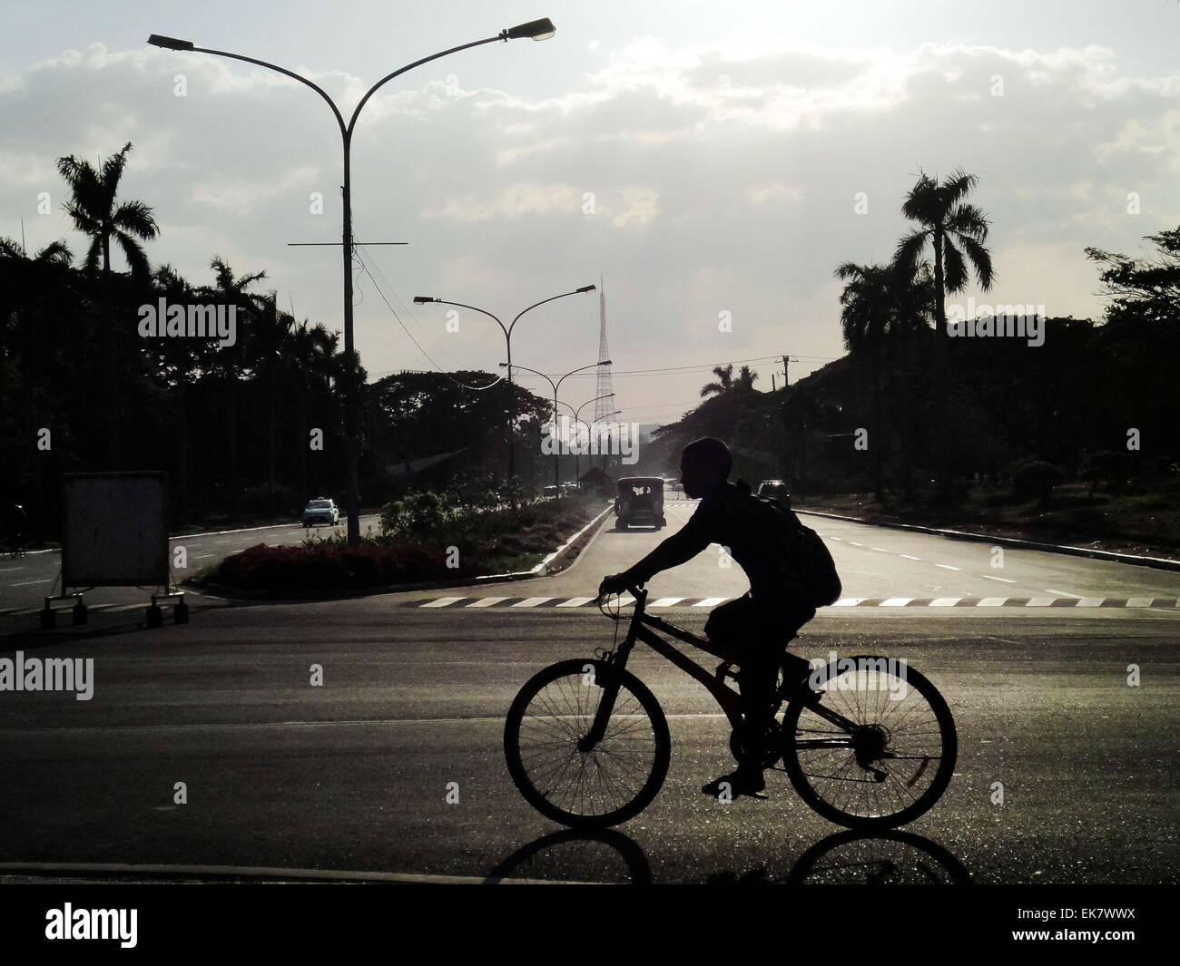 Quezon City, Philippines. 07th Apr, 2015. A Filipino cyclist rides his ...