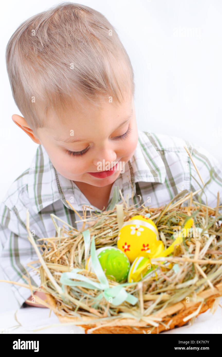 Little boy with easter eggs in basket Stock Photo - Alamy