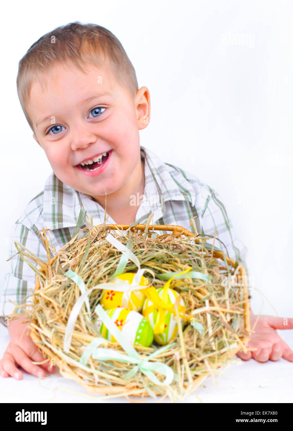 Little boy with easter eggs in basket Stock Photo - Alamy