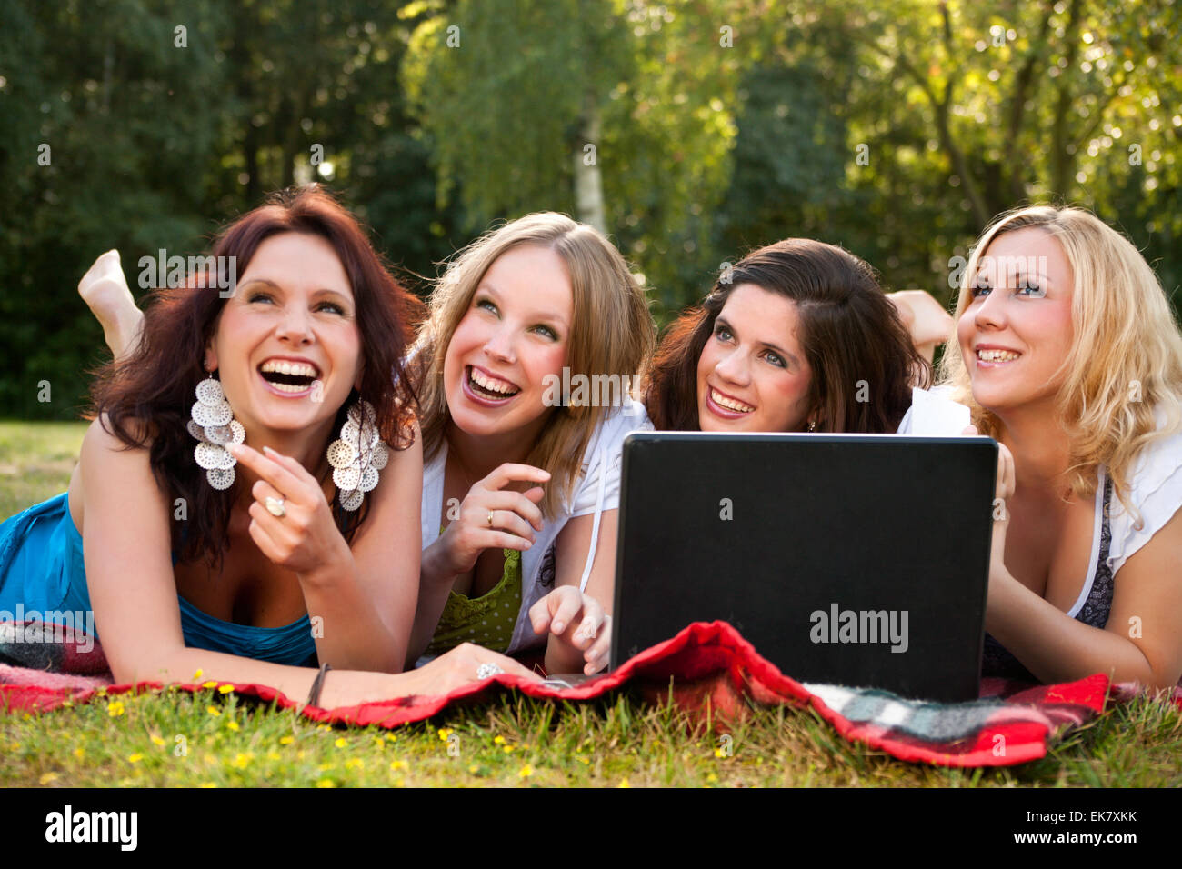 Happy women with a computer Stock Photo - Alamy