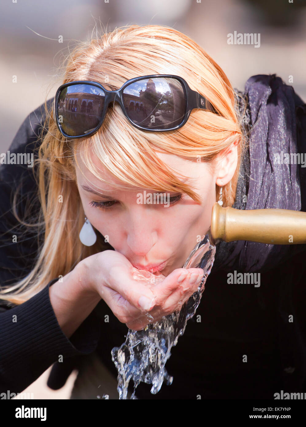 Lady drinking tap water Stock Photo - Alamy