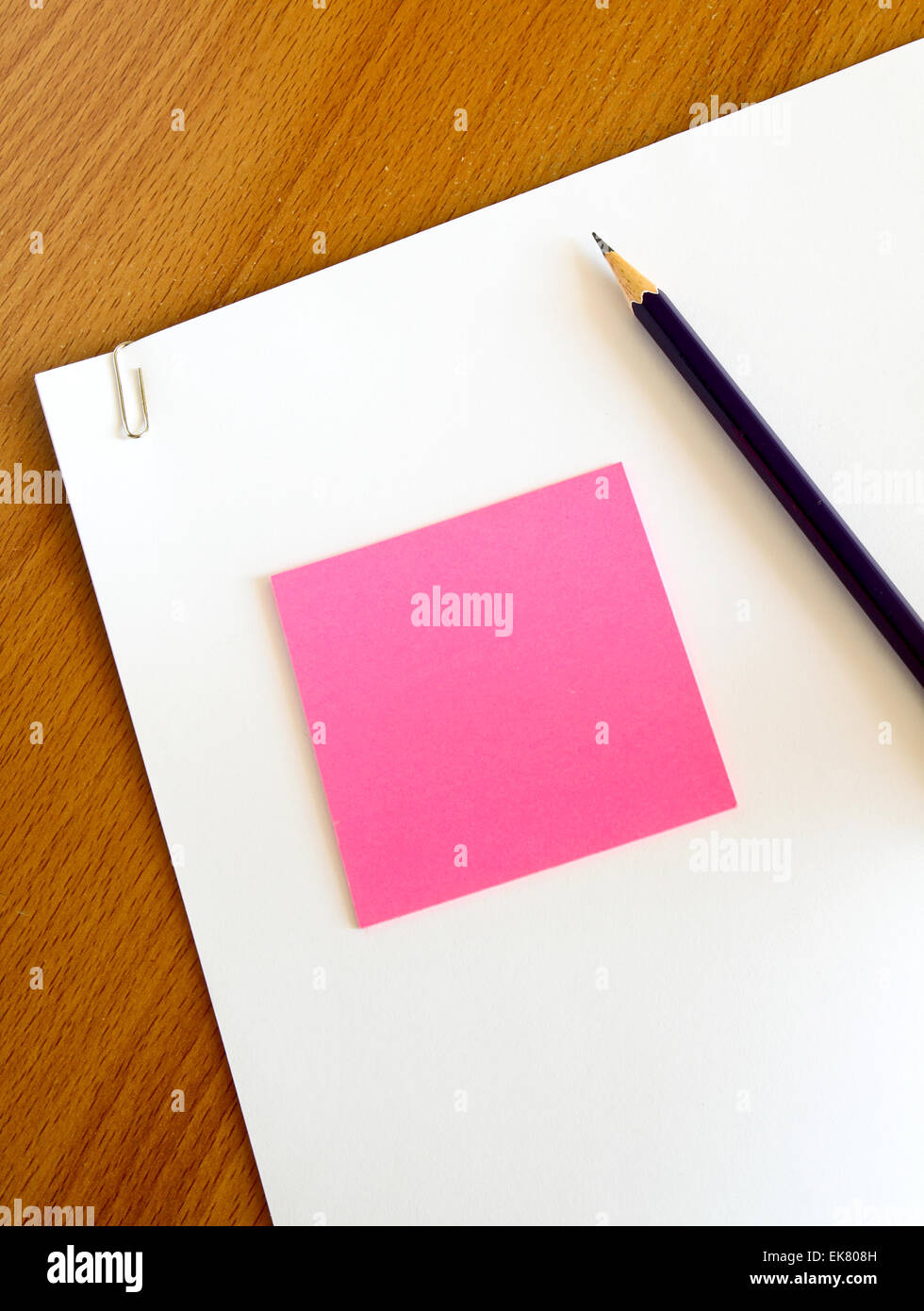 white paper with pencil and pink memo on table Stock Photo - Alamy