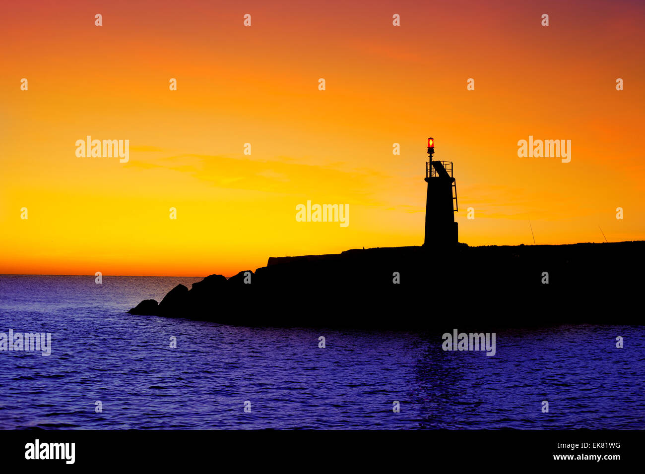 Golden sunrise sunset in sea red beacon lighthouse Stock Photo - Alamy