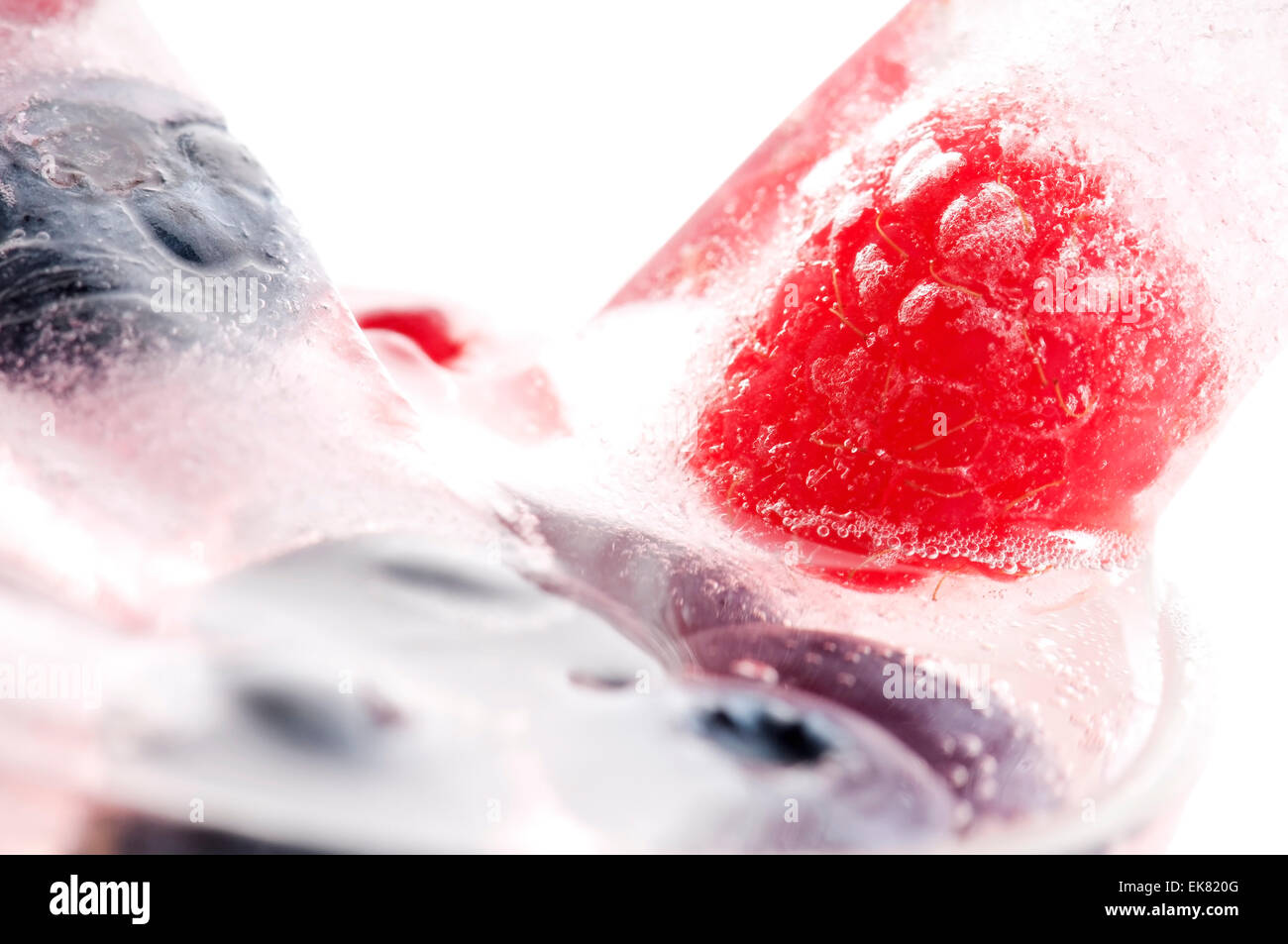Raspberry and blackberry frozen in ice sticks Stock Photo - Alamy