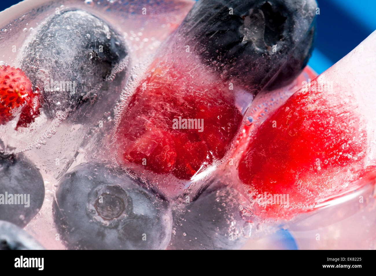 Raspberry and blackberry frozen in ice sticks Stock Photo - Alamy