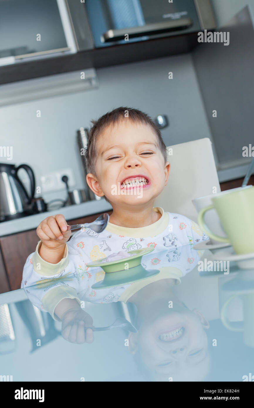 Happy Boy Eating Breakfast Stock Photo - Alamy