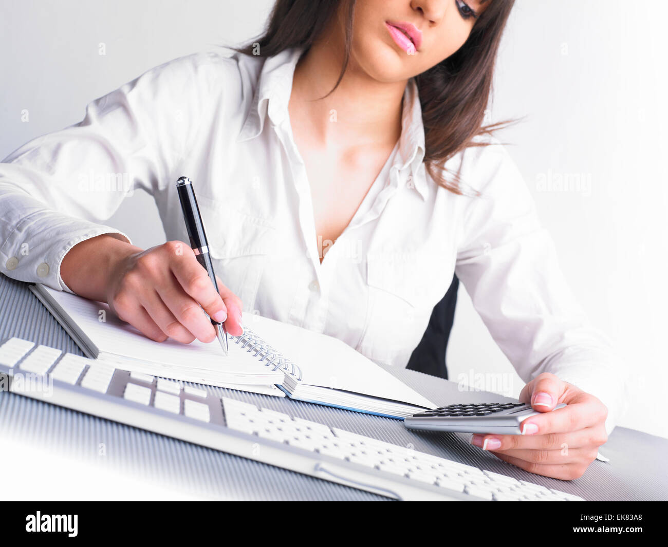 Office Assistant writing Schedule Stock Photo - Alamy