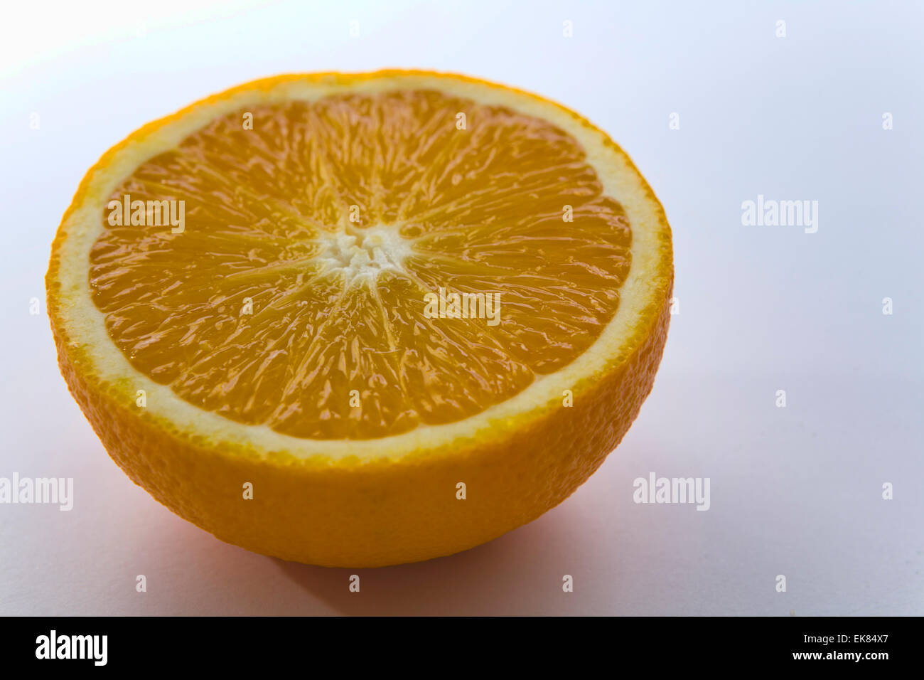 Half an orange isolated over a white background Stock Photo - Alamy