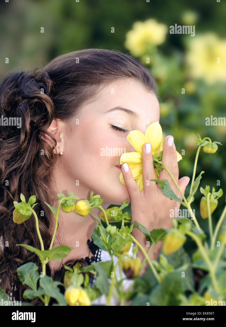 Girl smelling a flower Stock Photo - Alamy