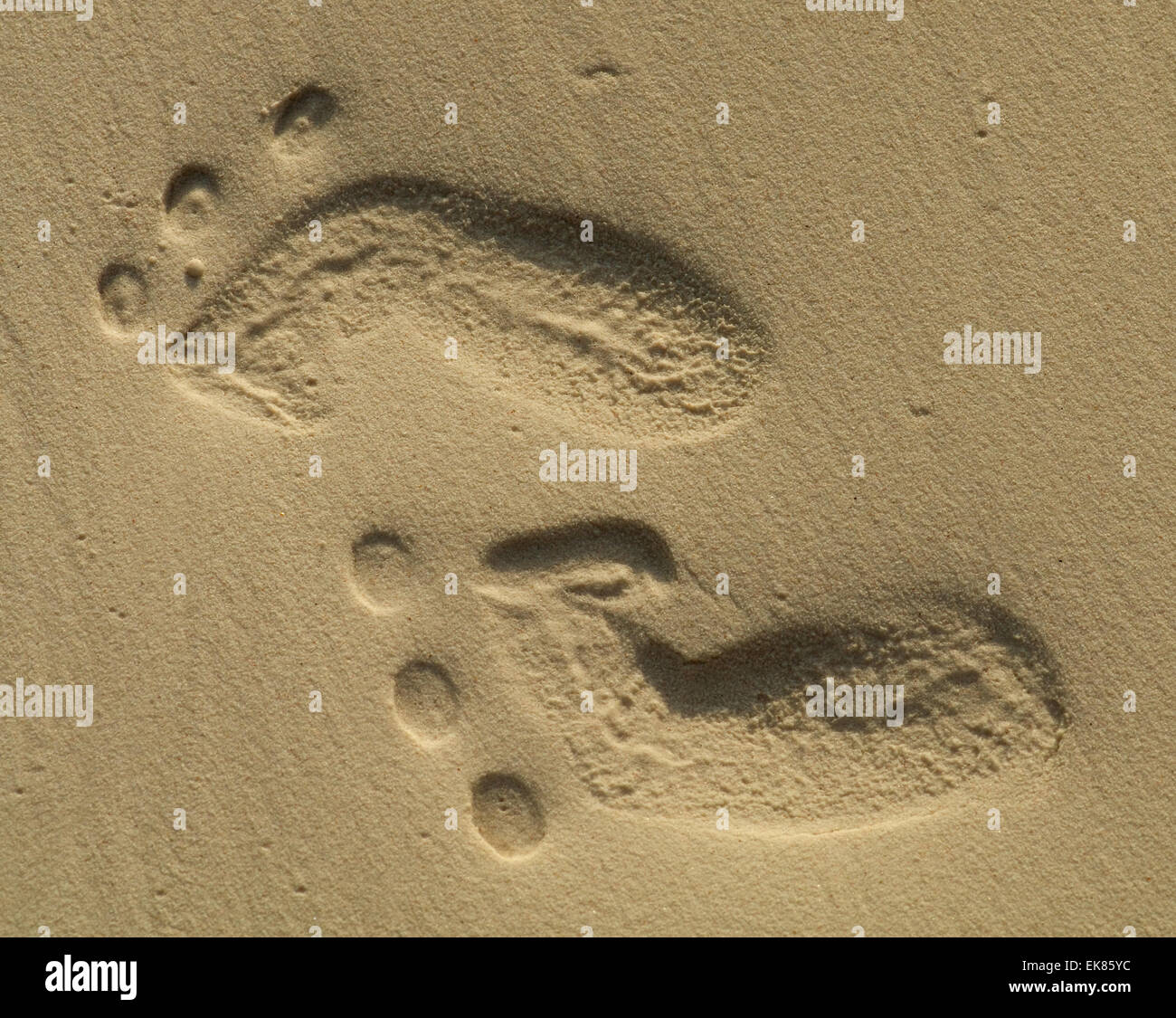 Two small footprints on sand Stock Photo - Alamy